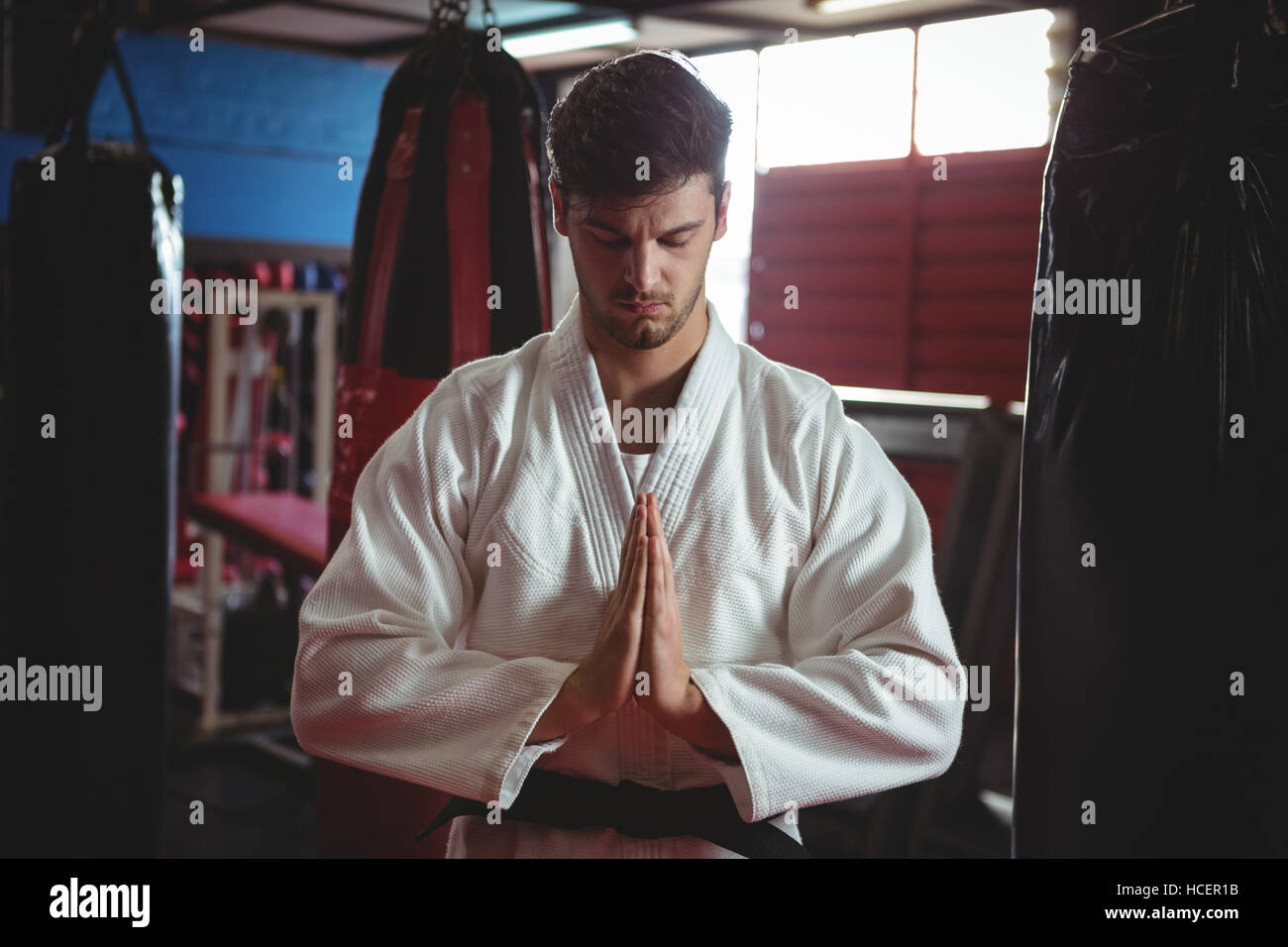 Karate player in prayer pose Stock Photo - Alamy