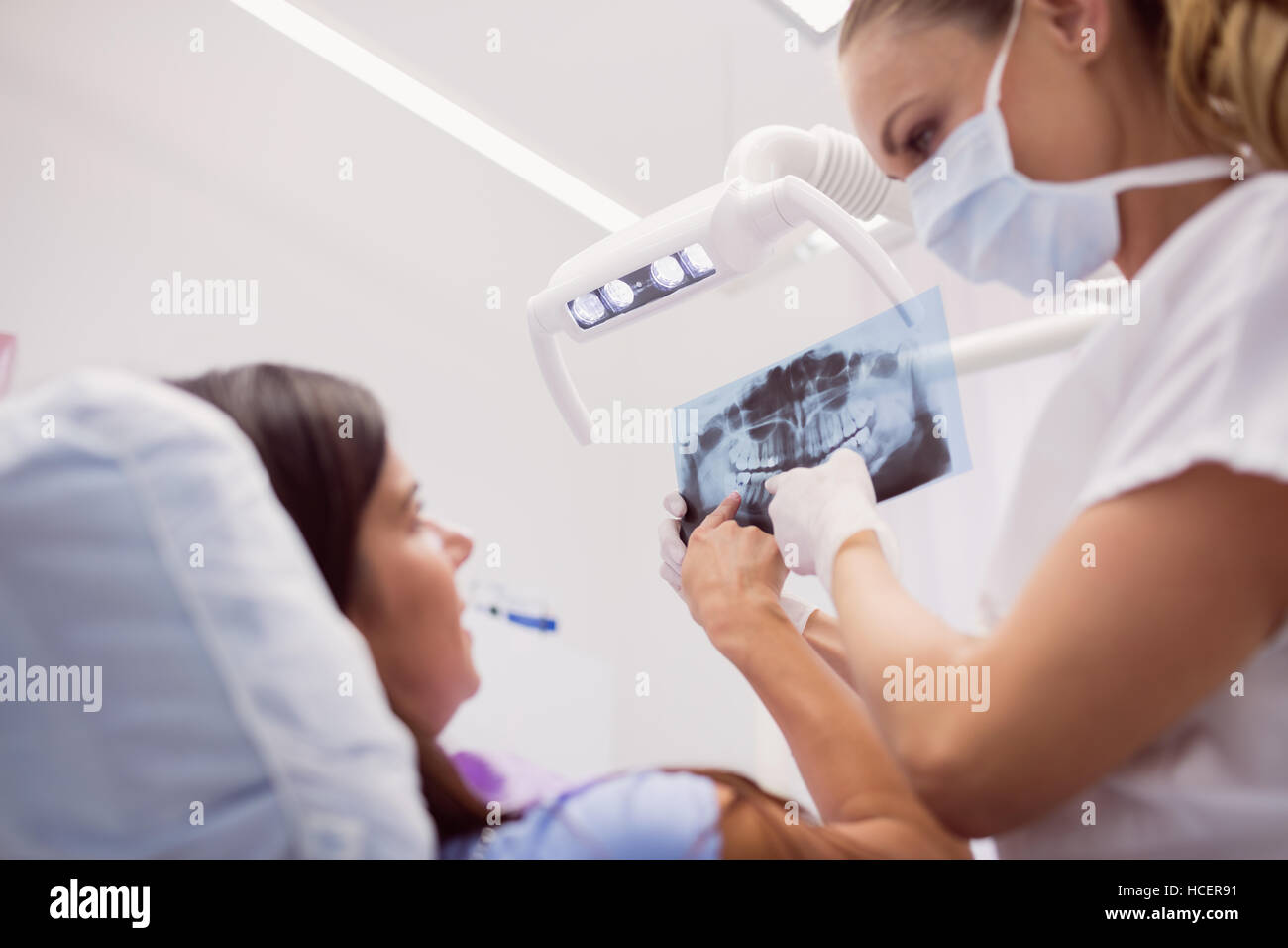 Female dentist showing x ray to patient at medical clinic hi-res stock ...