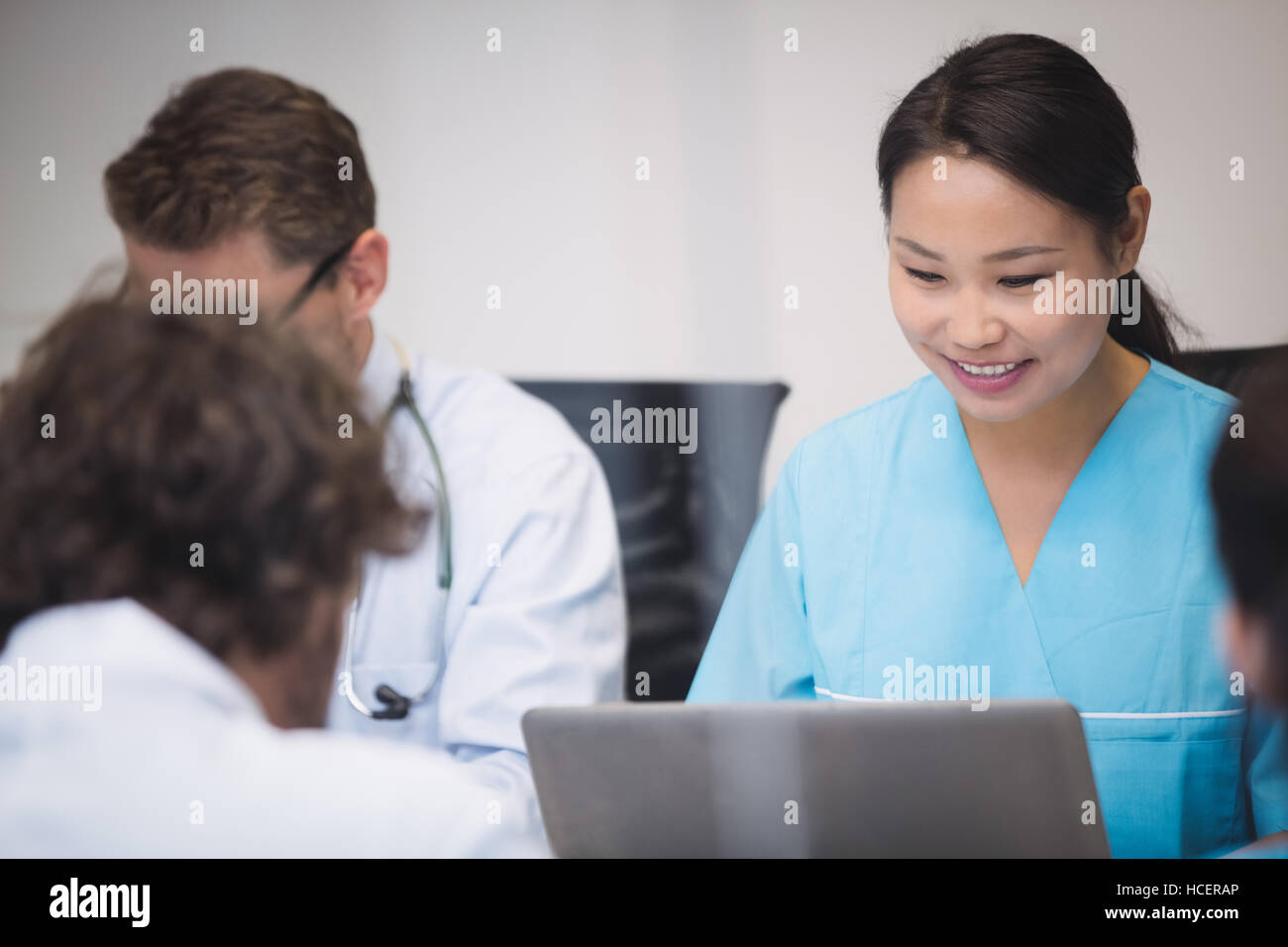 Nurse using laptop in conference room Stock Photo - Alamy