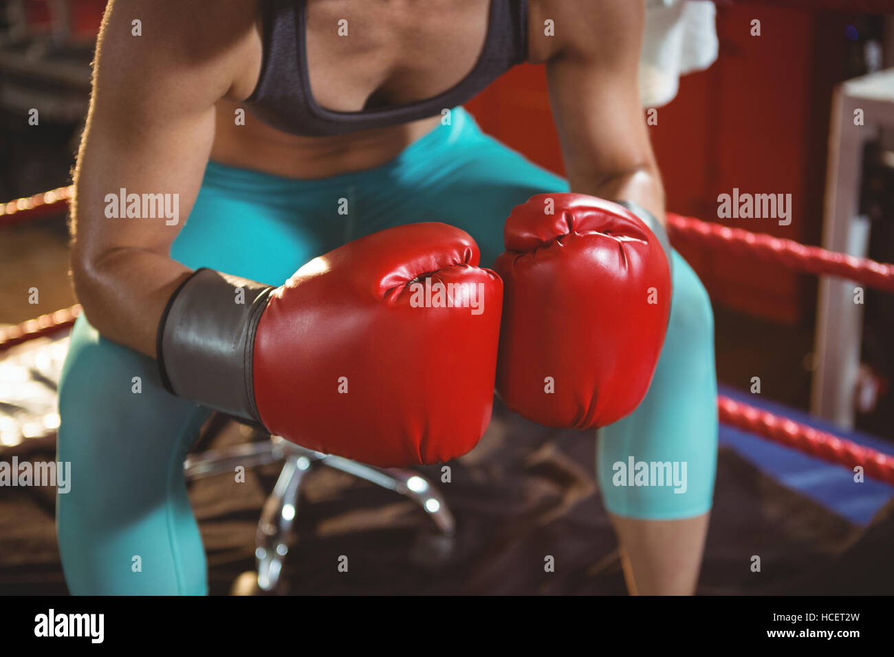 Female boxer sitting in the ring Stock Photo - Alamy
