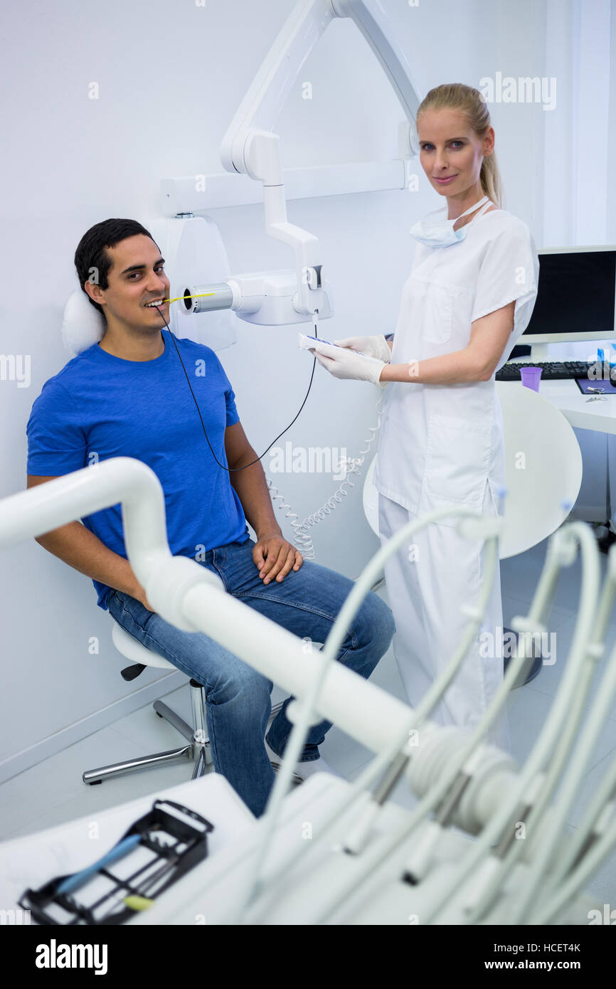 Female dentist taking x-ray of patients teeth Stock Photo - Alamy