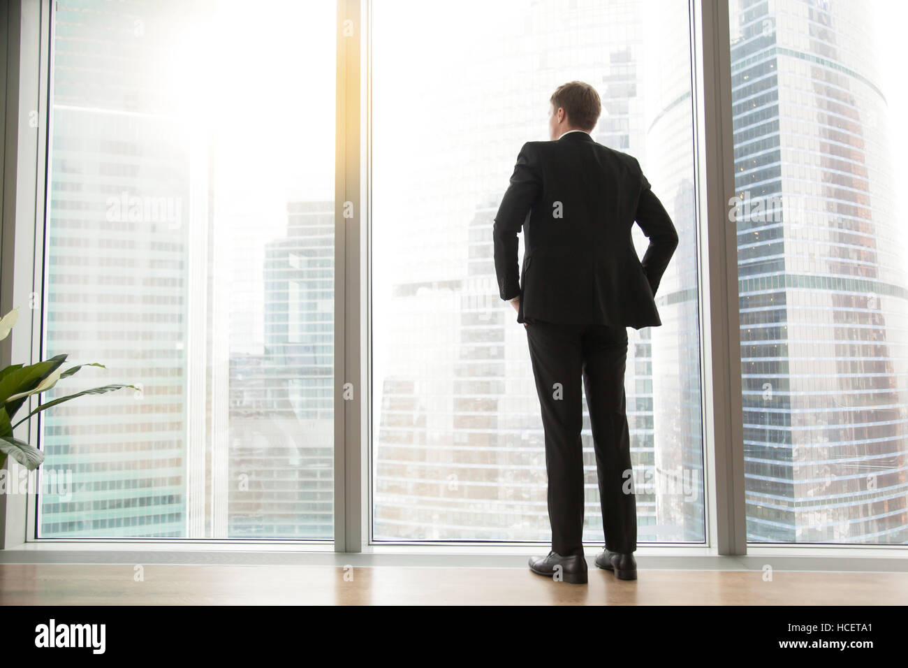 Full length back view of successful businessman in big city Stock Photo ...