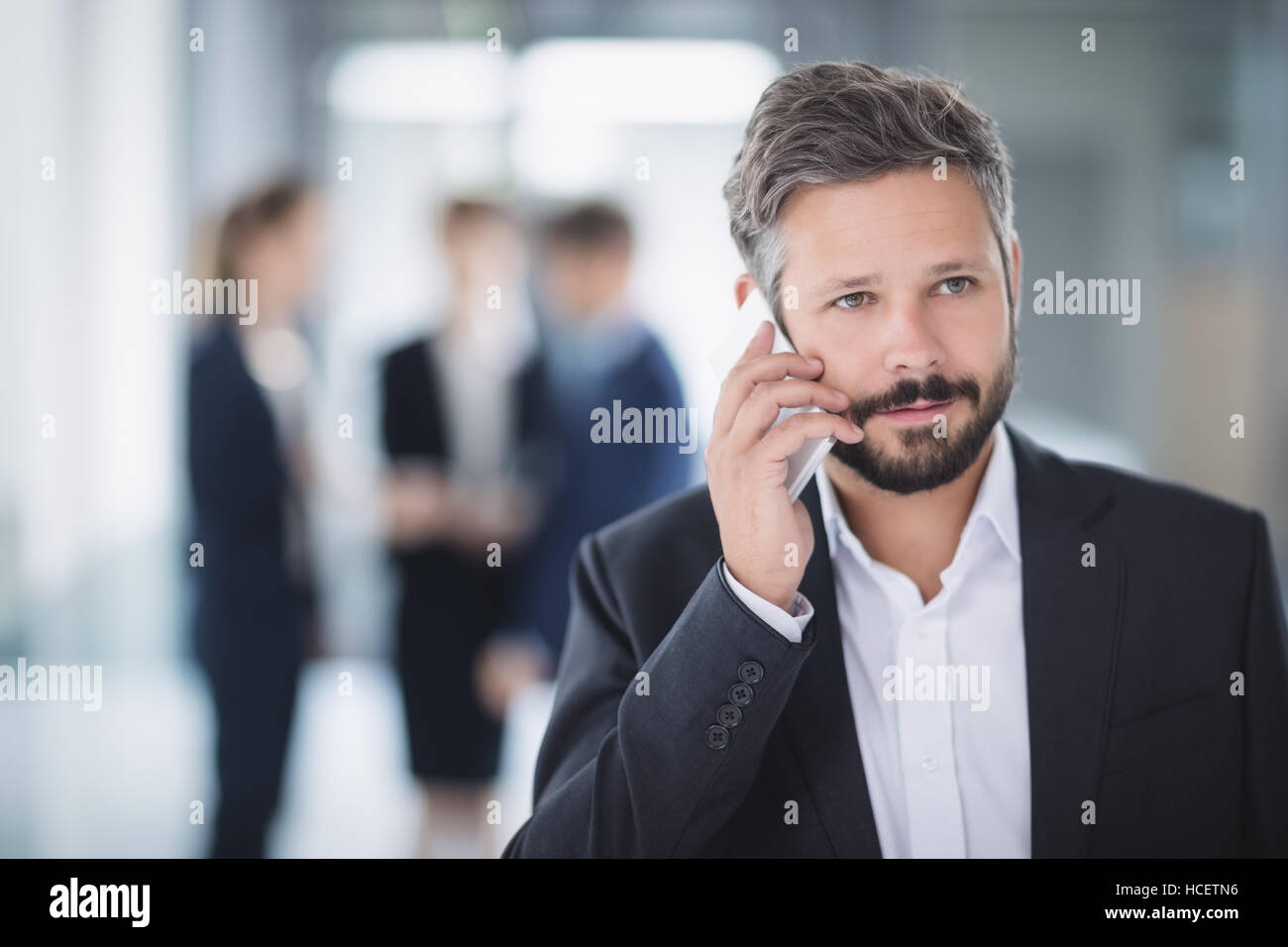 Young successful businessman speaking on hi-res stock photography and ...