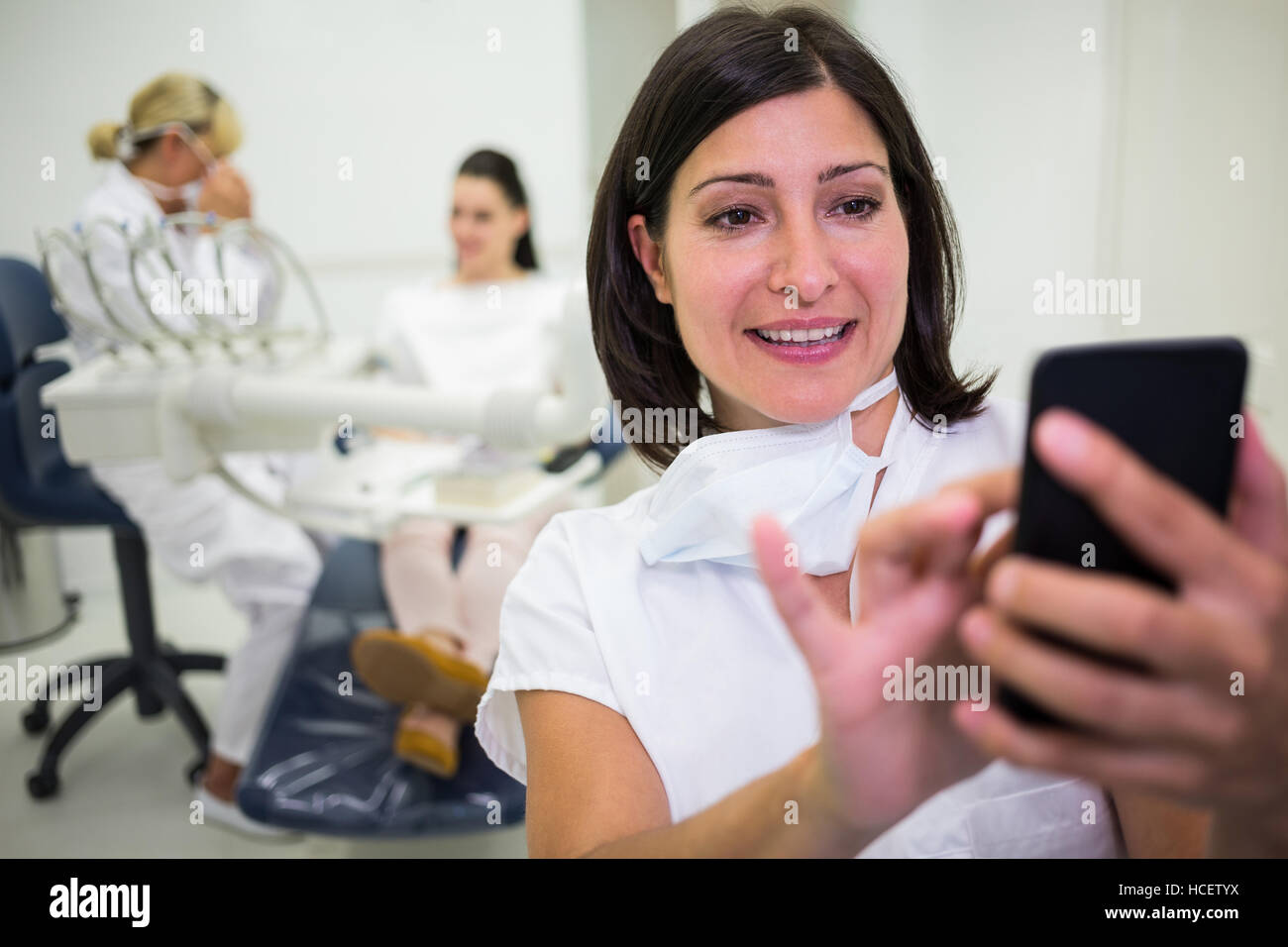 Female doctor using mobile phone Stock Photo - Alamy
