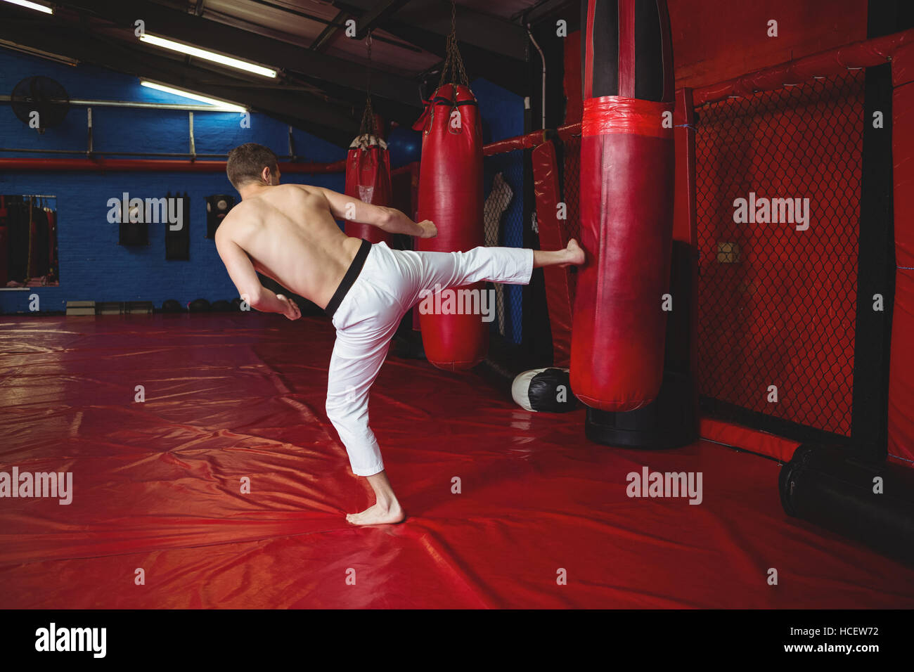 Karate player practicing kickboxing Stock Photo - Alamy