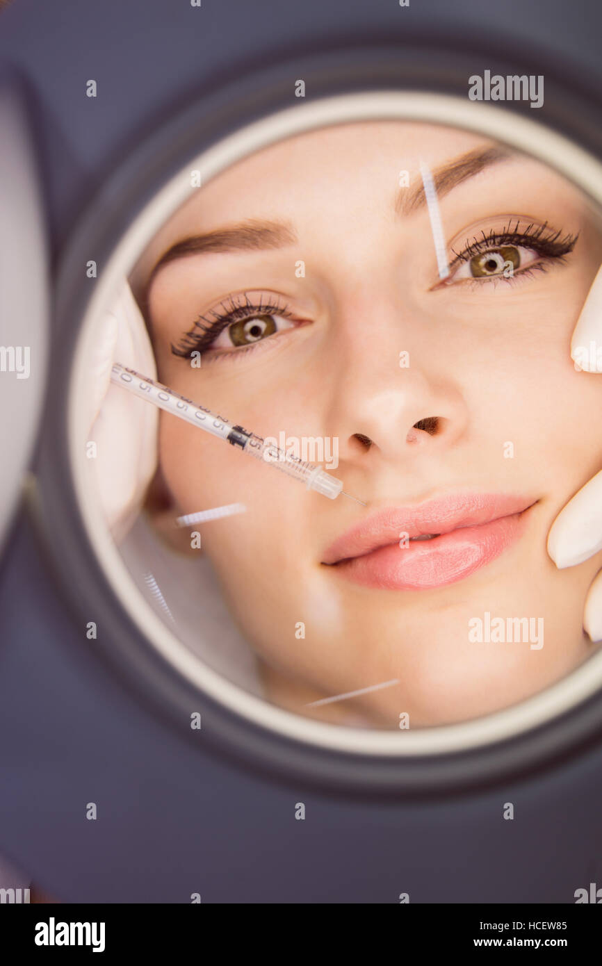 Female patient receiving an injection on her face Stock Photo - Alamy