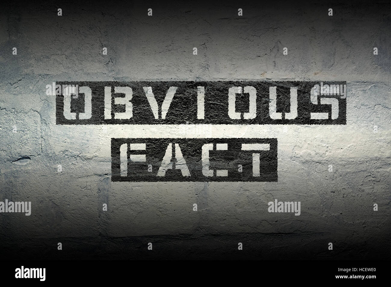 obvious fact stencil print on the grunge white brick wall Stock Photo ...