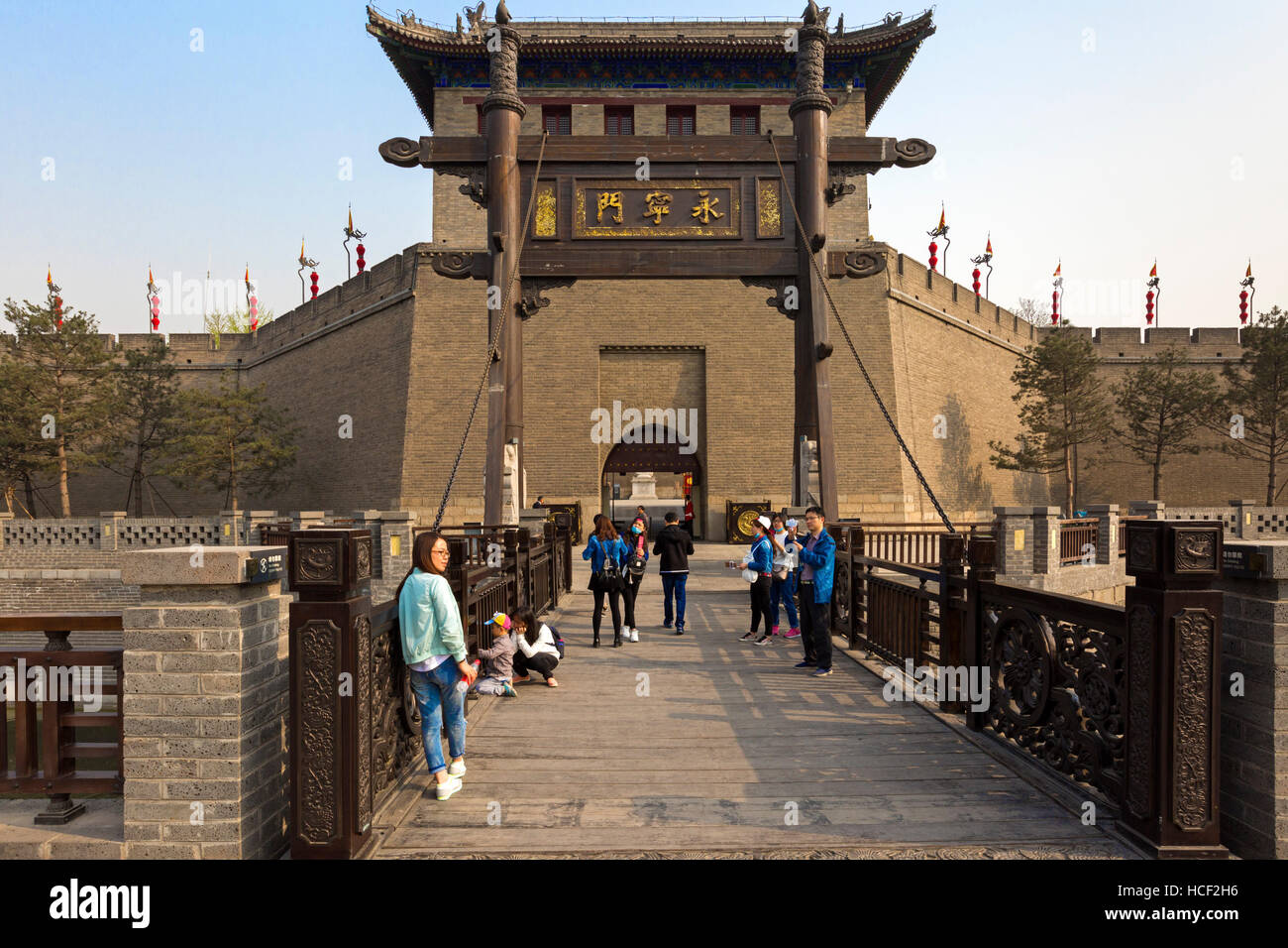 Tourists at Xian East Gate drawbridge entrance to city walls, Shaanxi ...