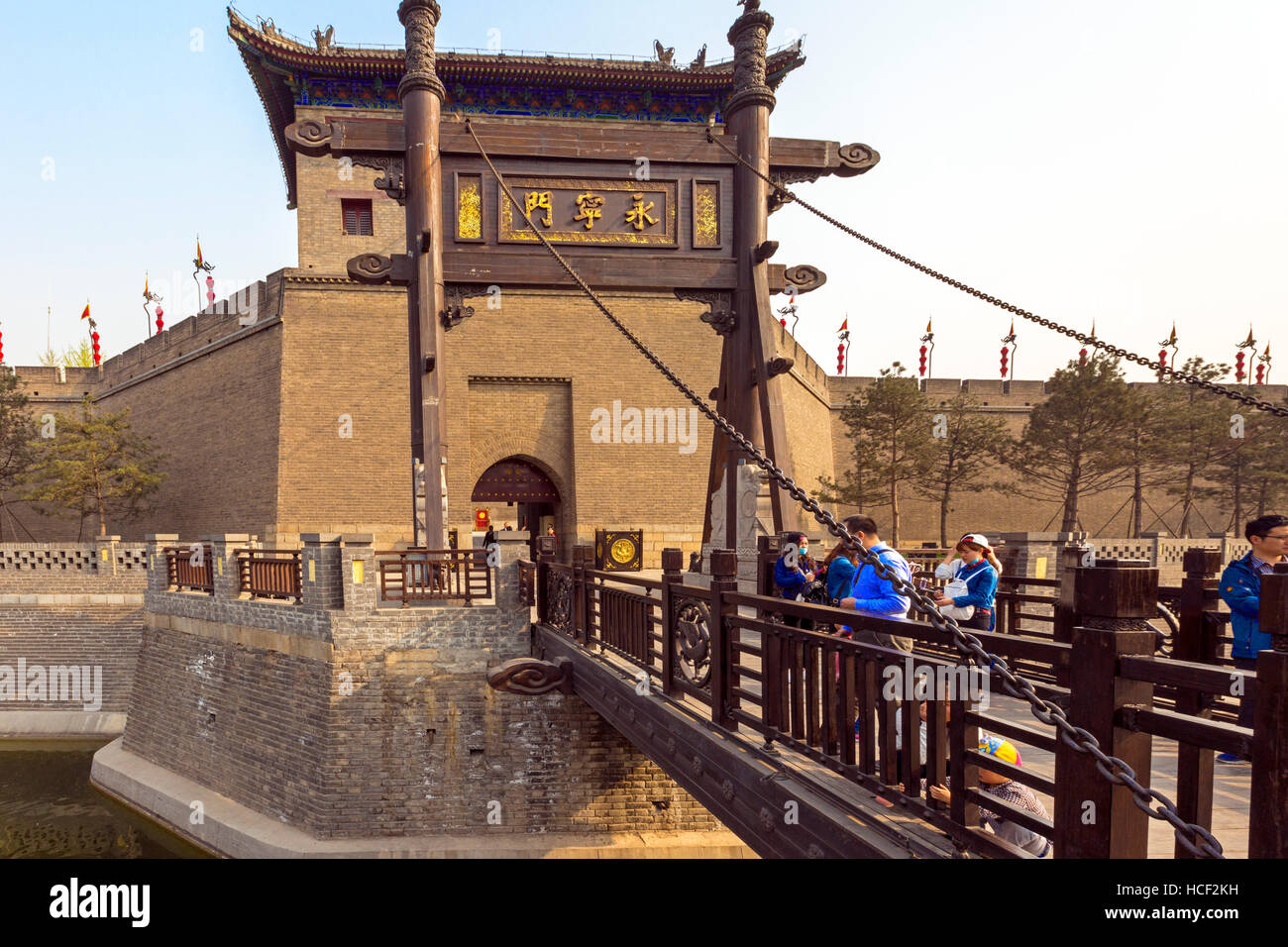Tourists at Xian East Gate drawbridge entrance to city walls, Shaanxi ...