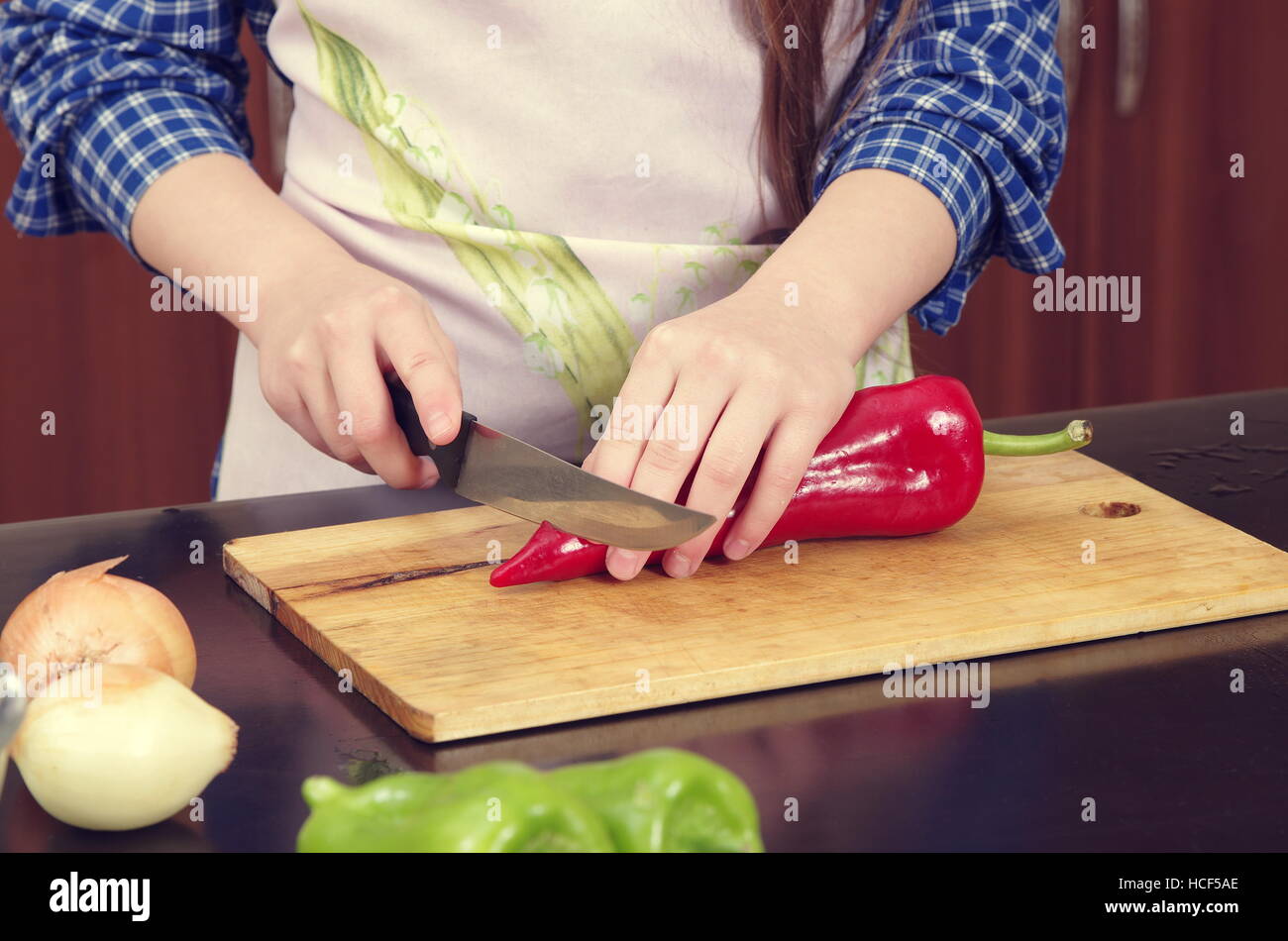 Little girl is cutting vegetables for salad closeup Stock Photo - Alamy