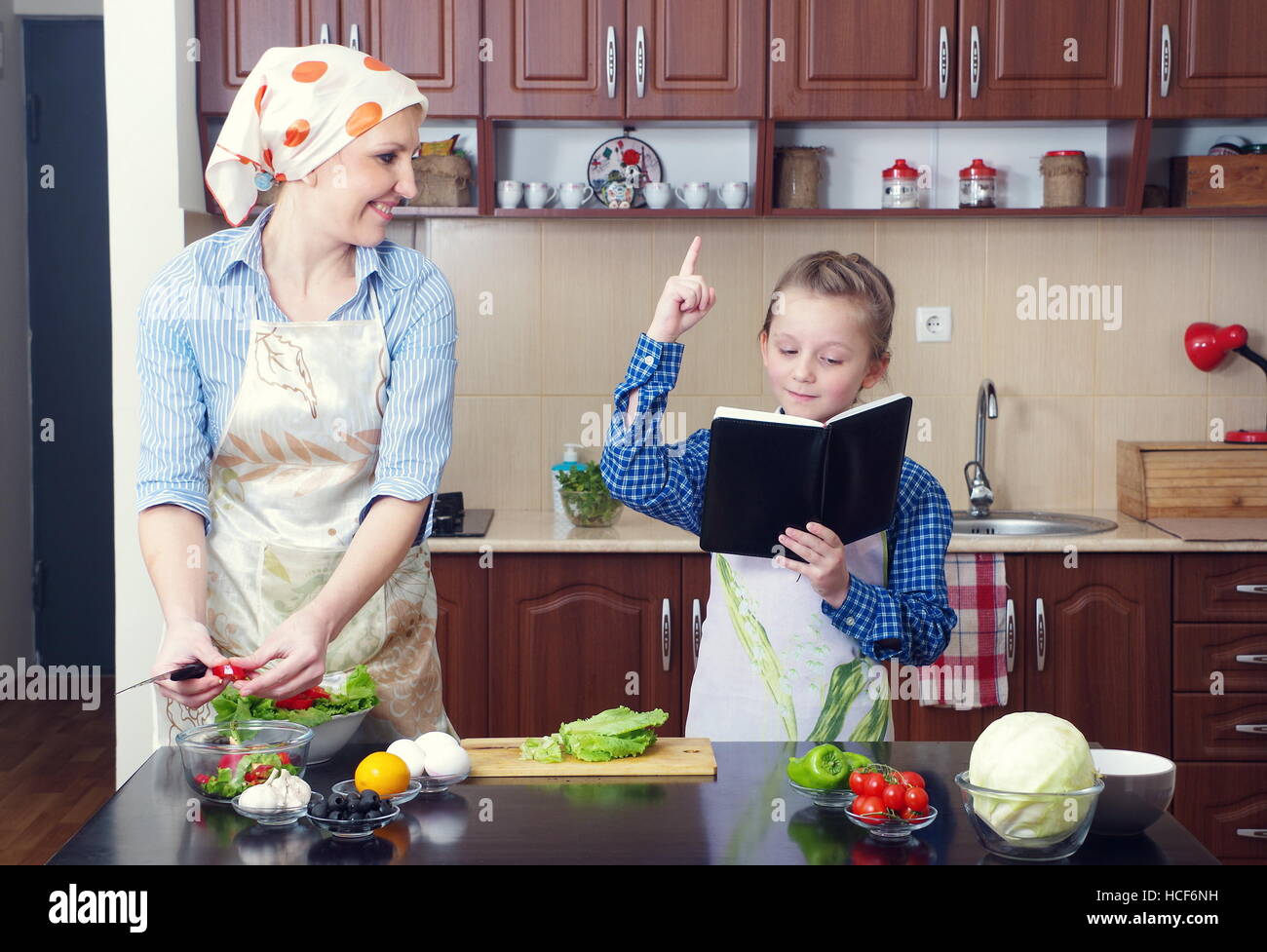 little girl is teaching her mother to cook in a kitchen with different ...