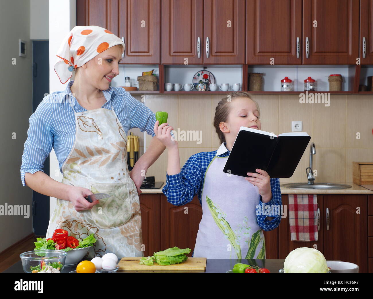 little girl is teaching her mother to cook in a kitchen with different ...