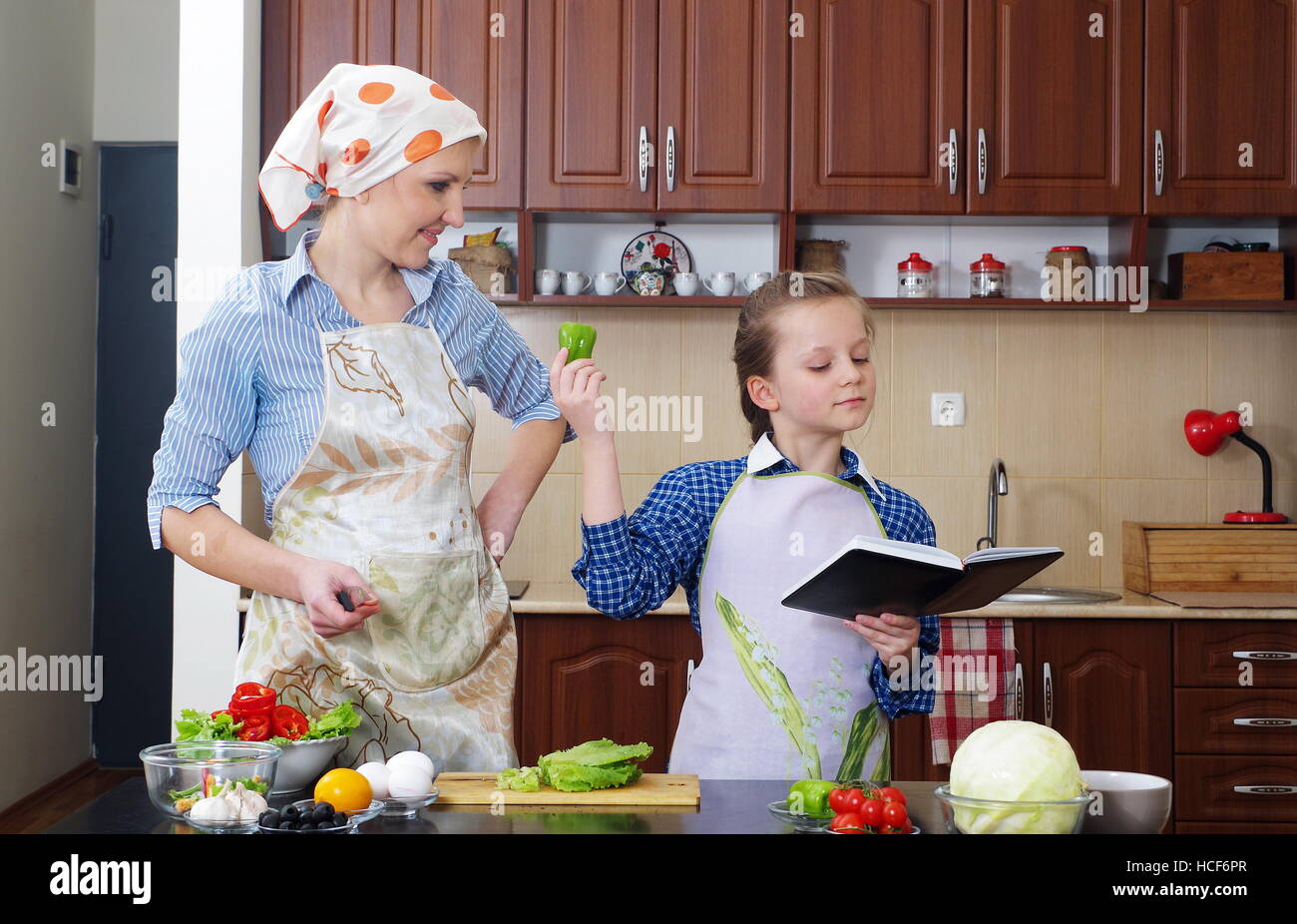 little girl is teaching her mother to cook in a kitchen with different ...