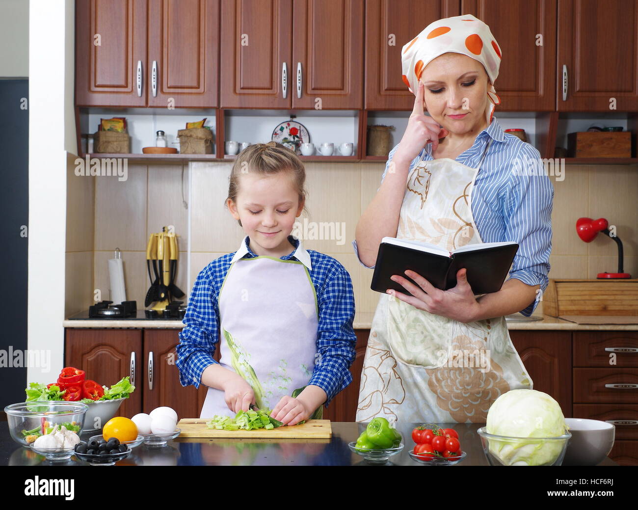 little girl is teaching her mother to cook in a kitchen with different ...