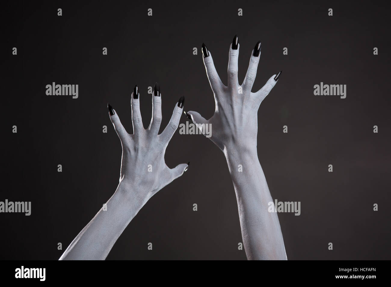 Demonic hands with black nails, Halloween body art Stock Photo - Alamy