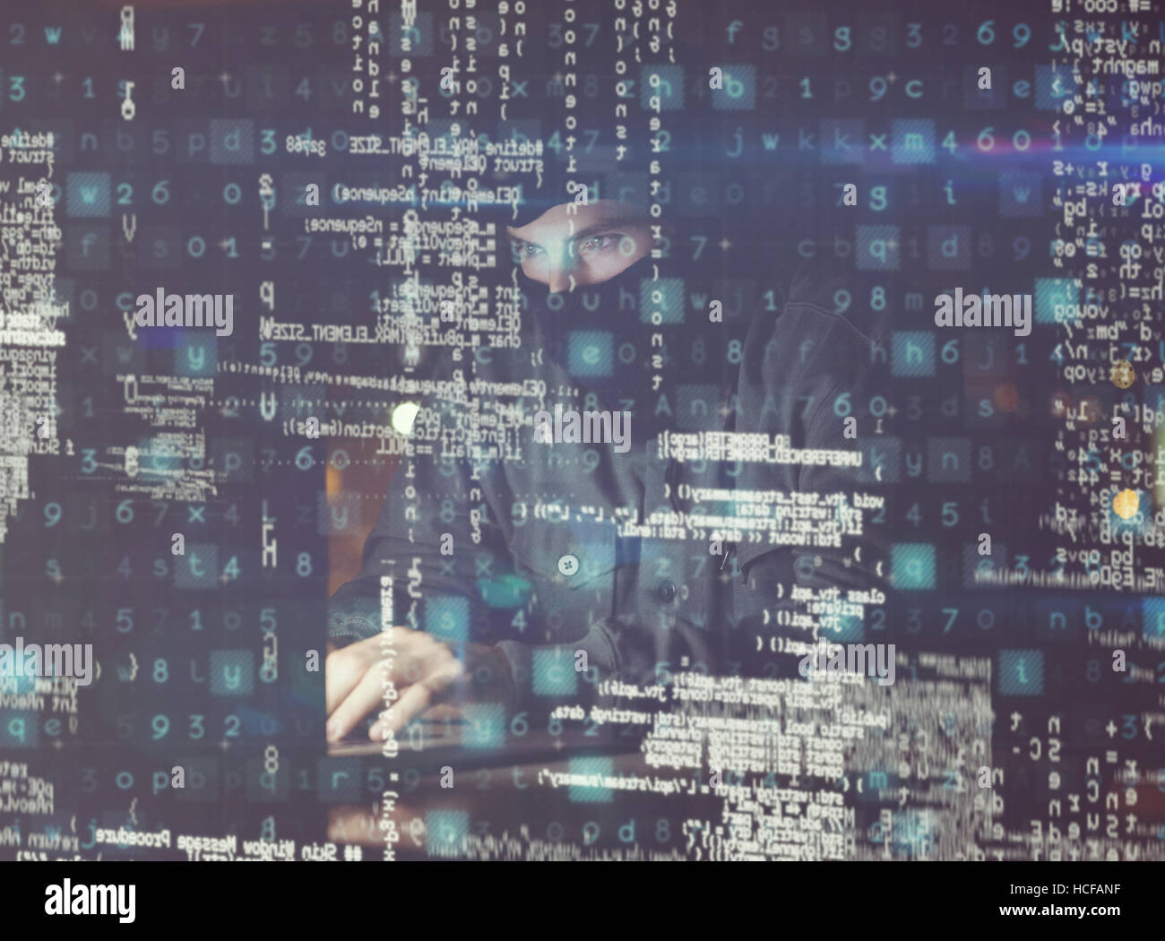Hacker using laptop Stock Photo - Alamy
