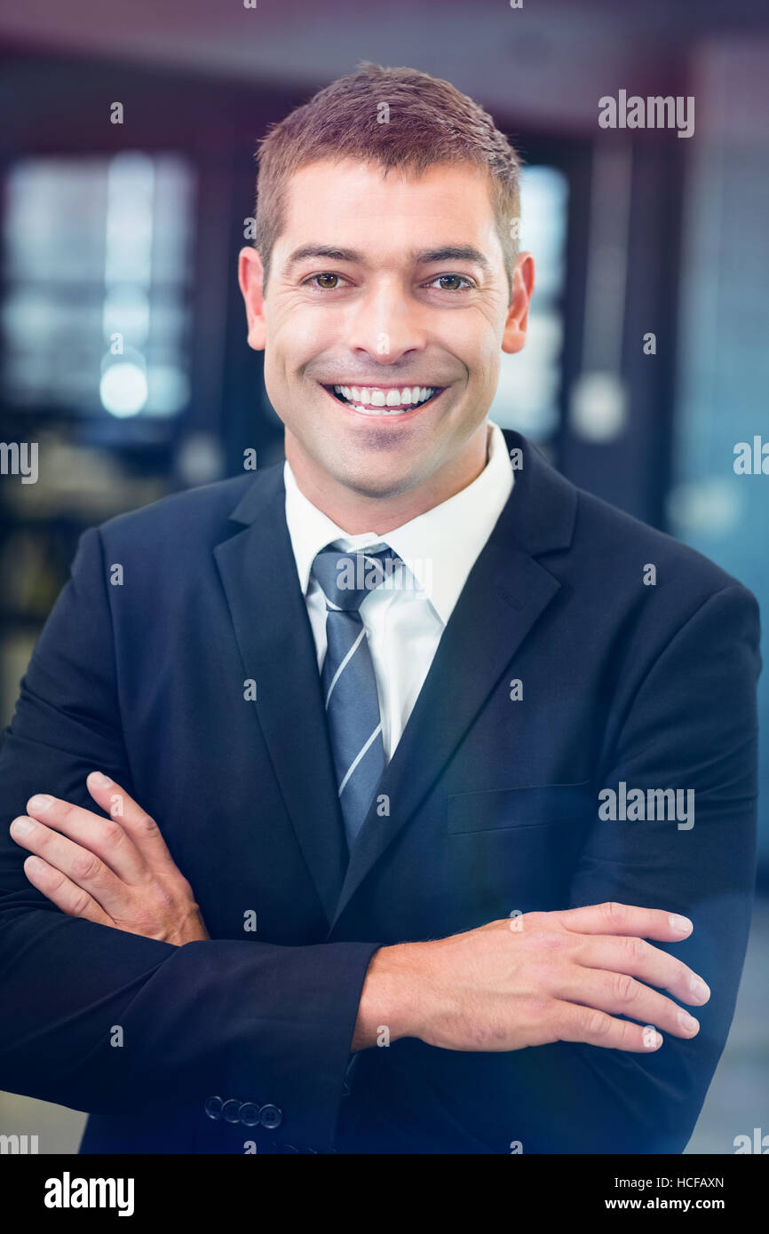 Portrait of businessman standing with arms crossed Stock Photo - Alamy