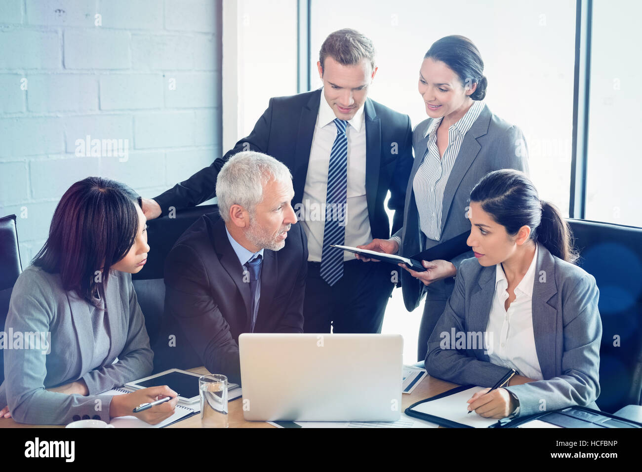 Businesspeople interacting in conference room Stock Photo - Alamy