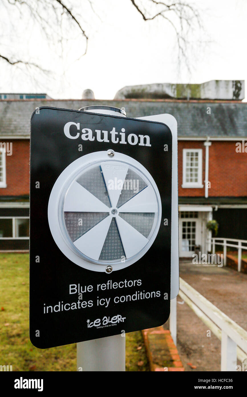 A high tech sign warning about icy conditions on a sloping surface ...