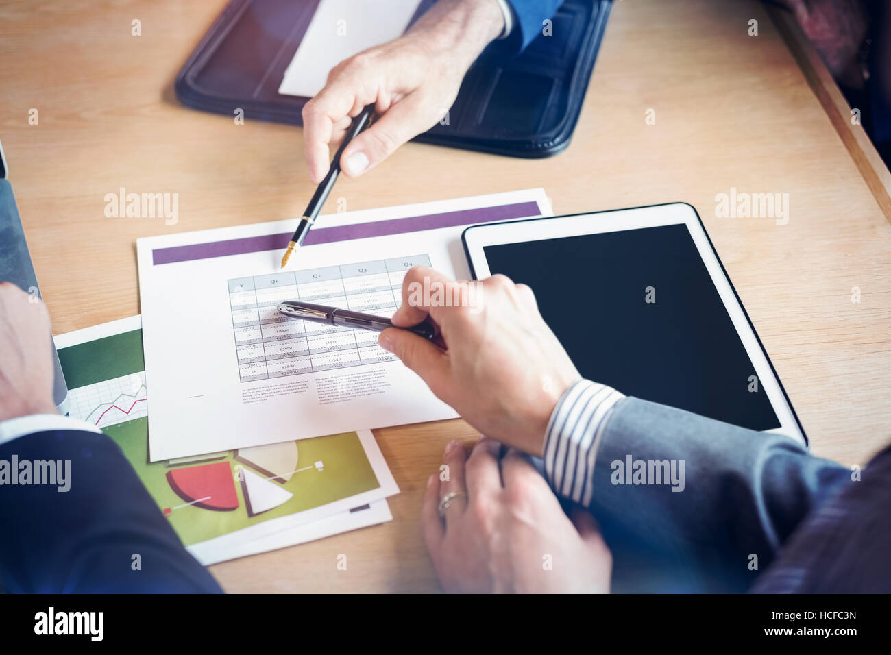 Businesspeople discussing the chart and graph Stock Photo - Alamy