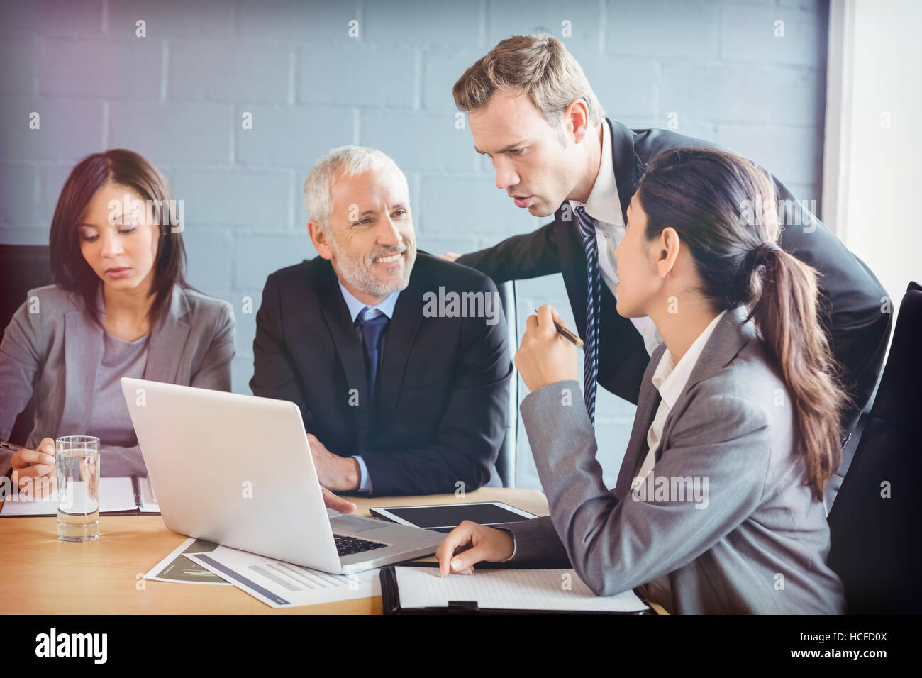 Businesspeople interacting in conference room Stock Photo - Alamy