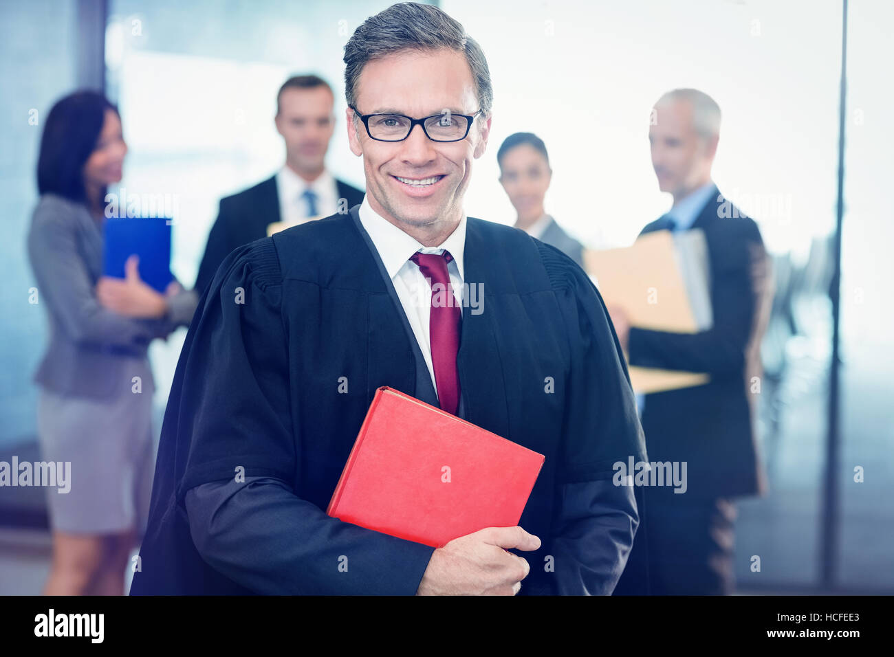 Portrait of lawyer holding law book Stock Photo - Alamy