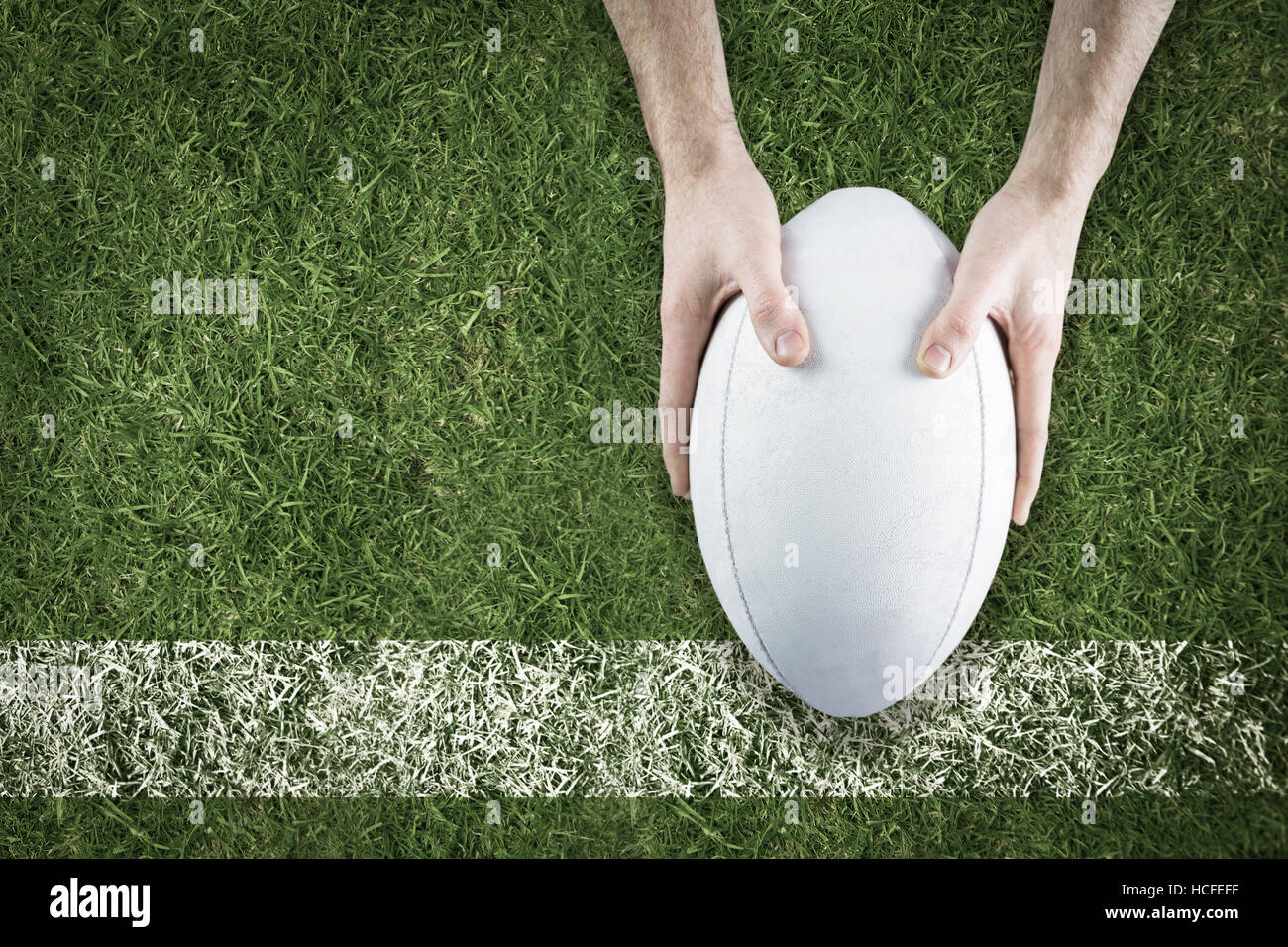 Composite image of a rugby player posing a rugby ball Stock Photo - Alamy