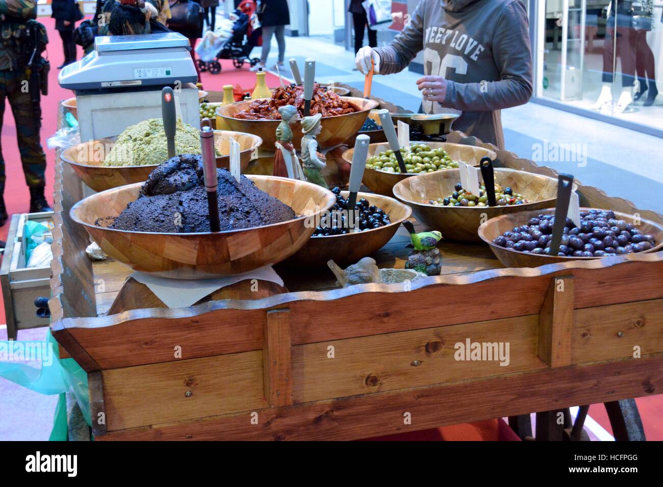 Wooden display case with green and black olives and olive paste Stock ...