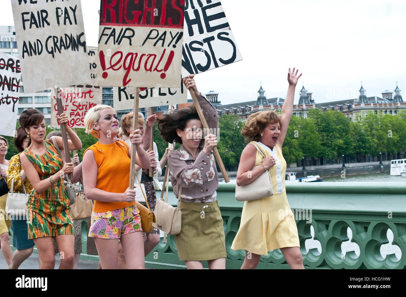 MADE IN DAGENHAM, women carrying signs, from left: Andrea Riseborough ...