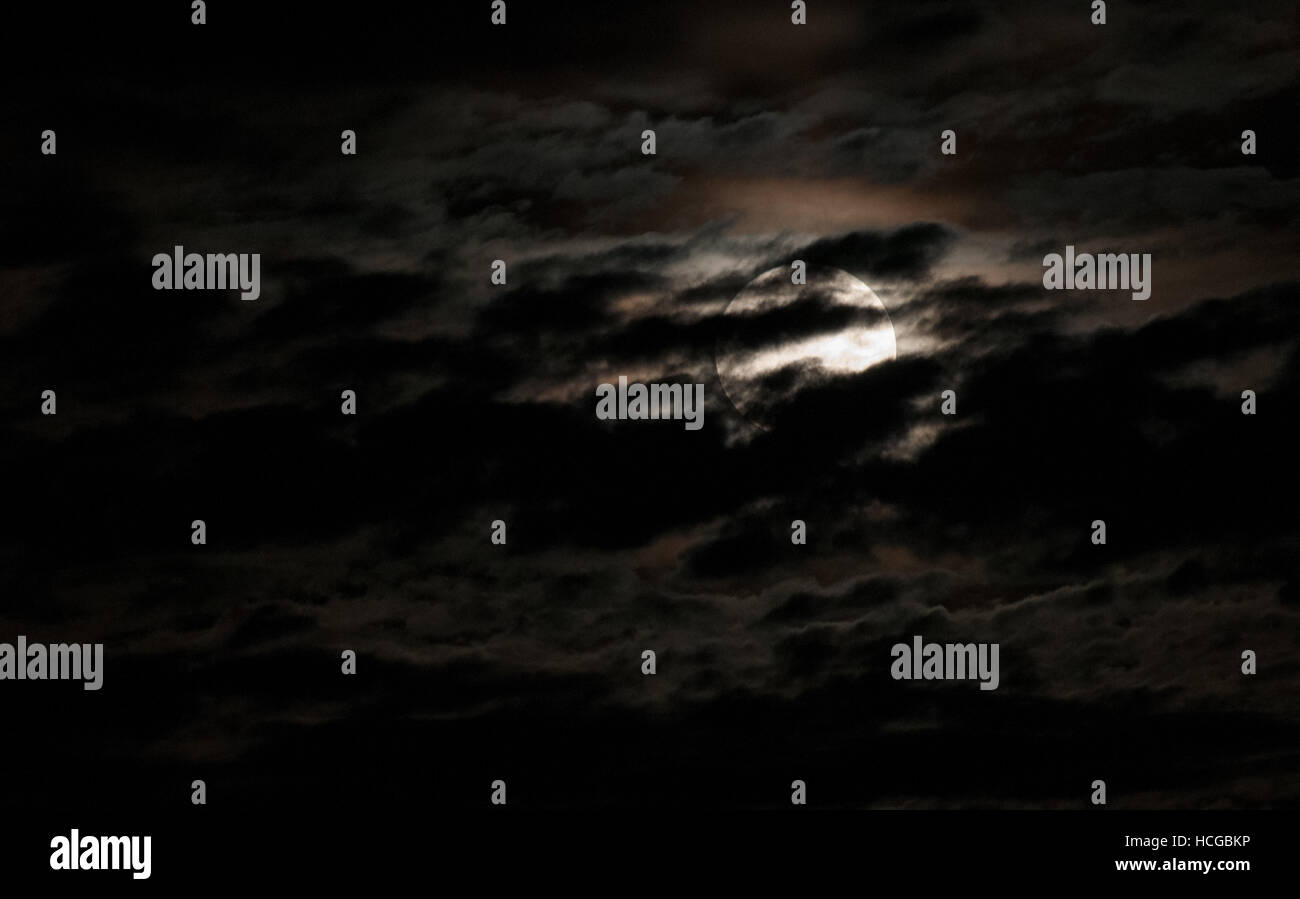 Full moon partially covered dark hi-res stock photography and images ...