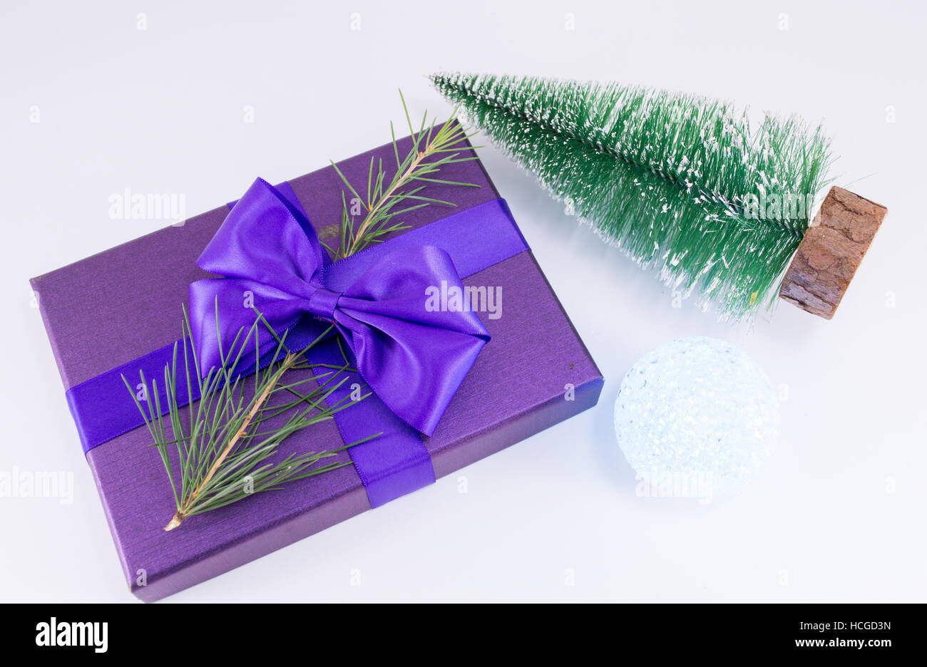 small christmas tree with a purple gift box Stock Photo - Alamy