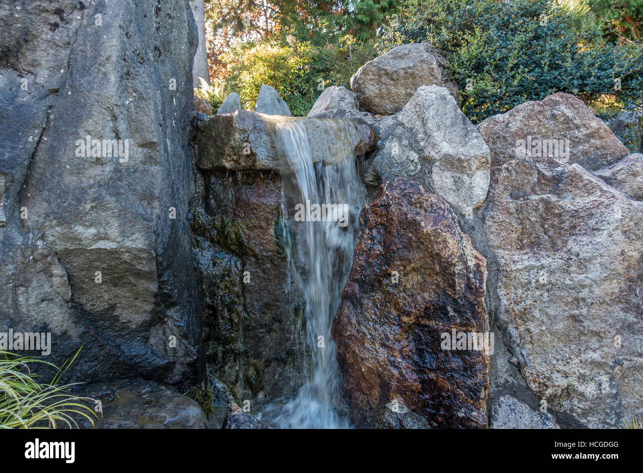 Water splashes over a rocky edge creating a waterfall. Shot taken in ...