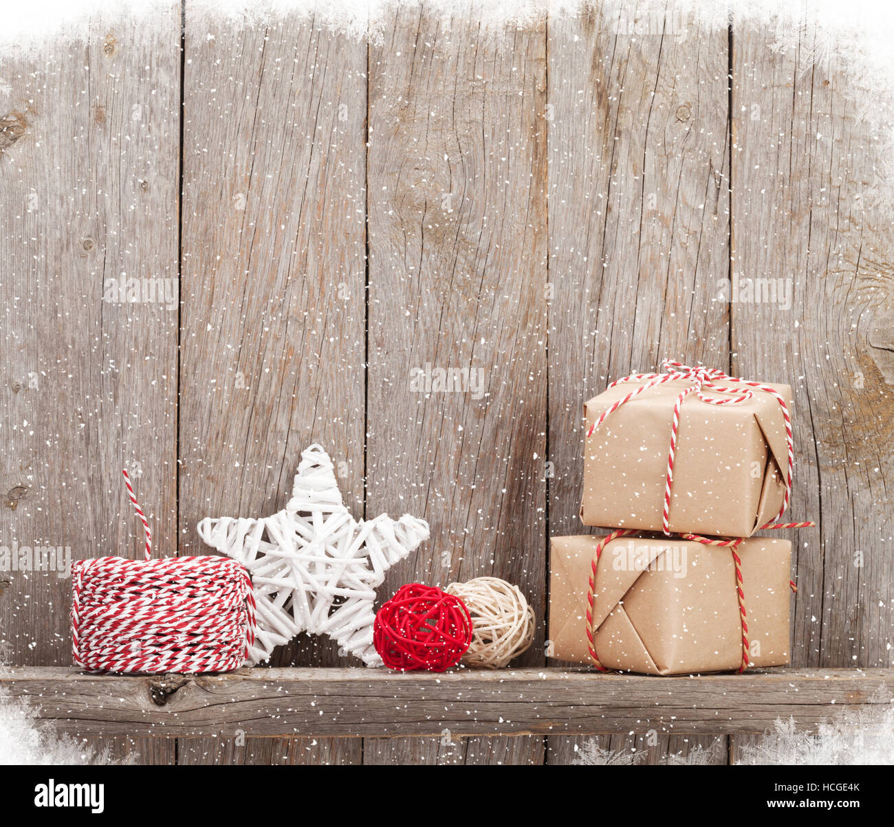 Christmas gift boxes and decor in front of wooden wall. View with copy ...