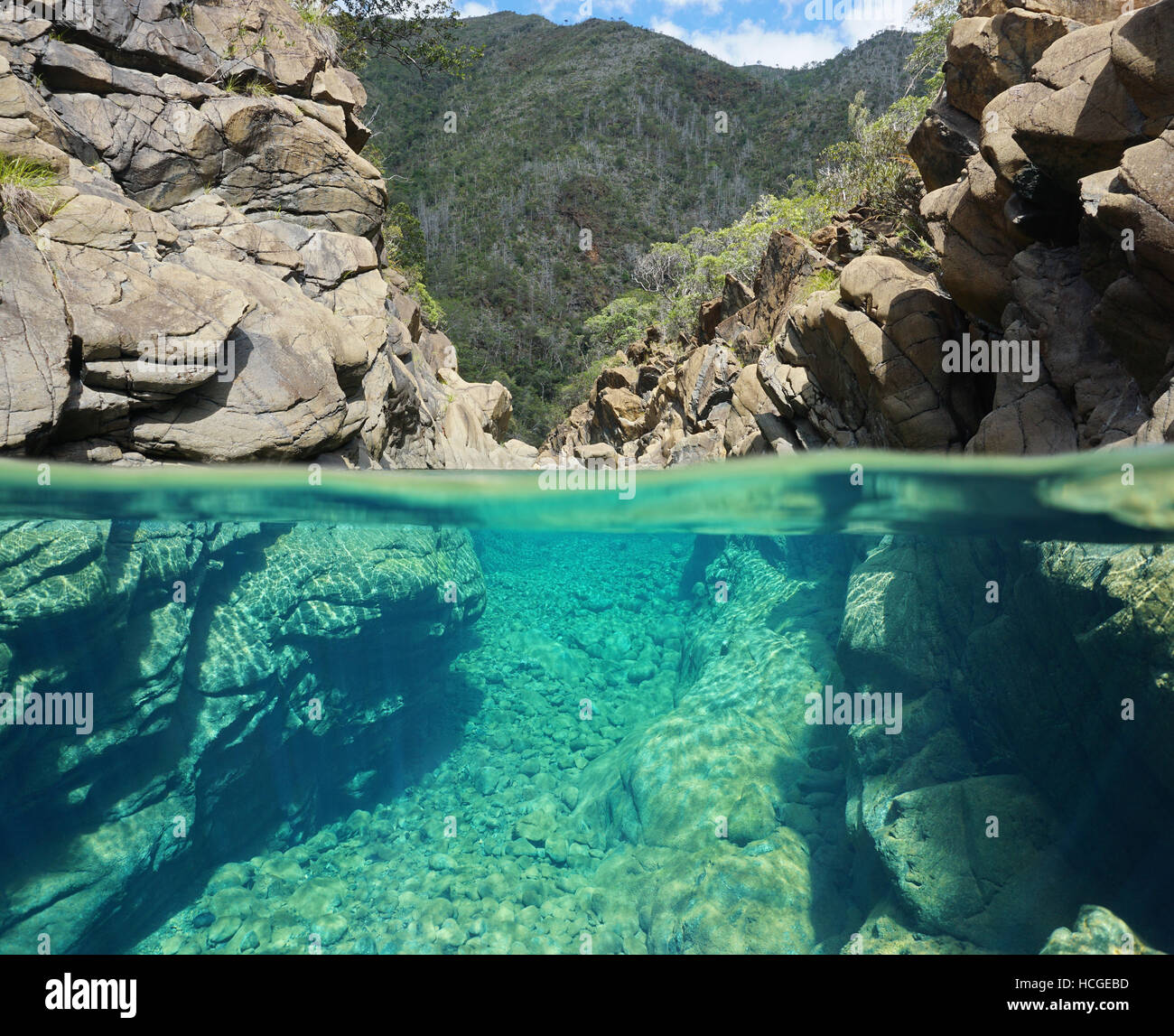 Rocks over and underwater split view in the river Dumbea, New Caledonia ...
