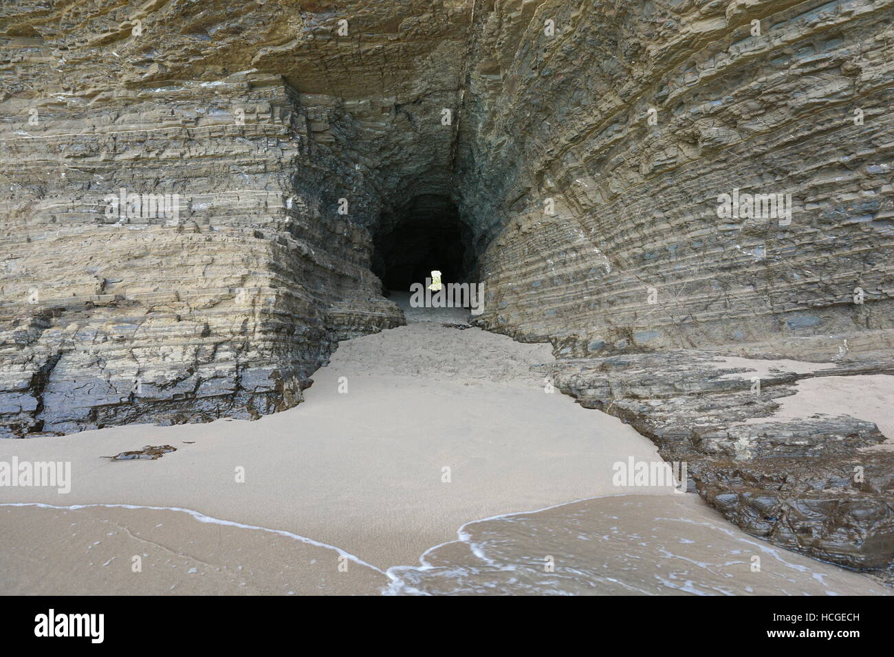 Tunnel in the rock on the coast, connecting beaches of La Roche Percee ...