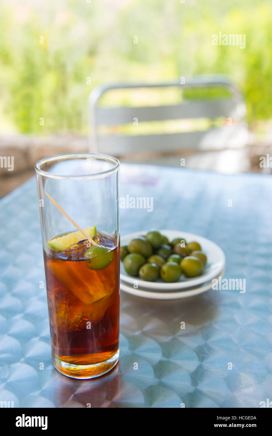 Glass of vermouth with green olives in a terrace. Spain Stock Photo - Alamy