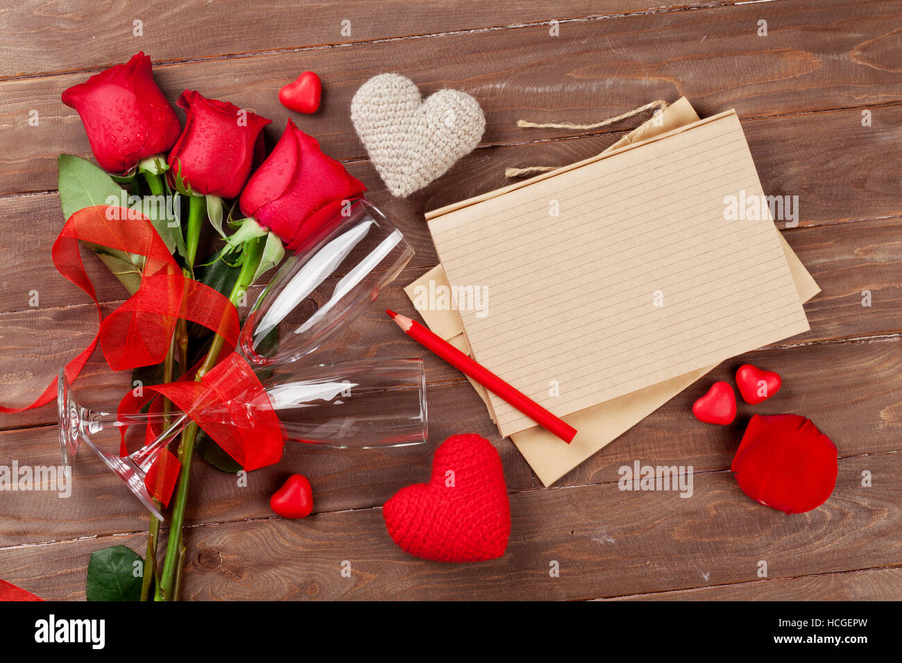 Love letter notepad, red roses and Valentines day hearts on wooden ...