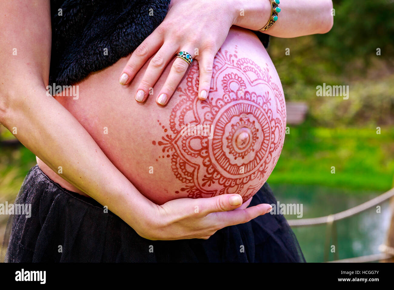 Young beautiful woman with pregnant belly showing Stock Photo - Alamy