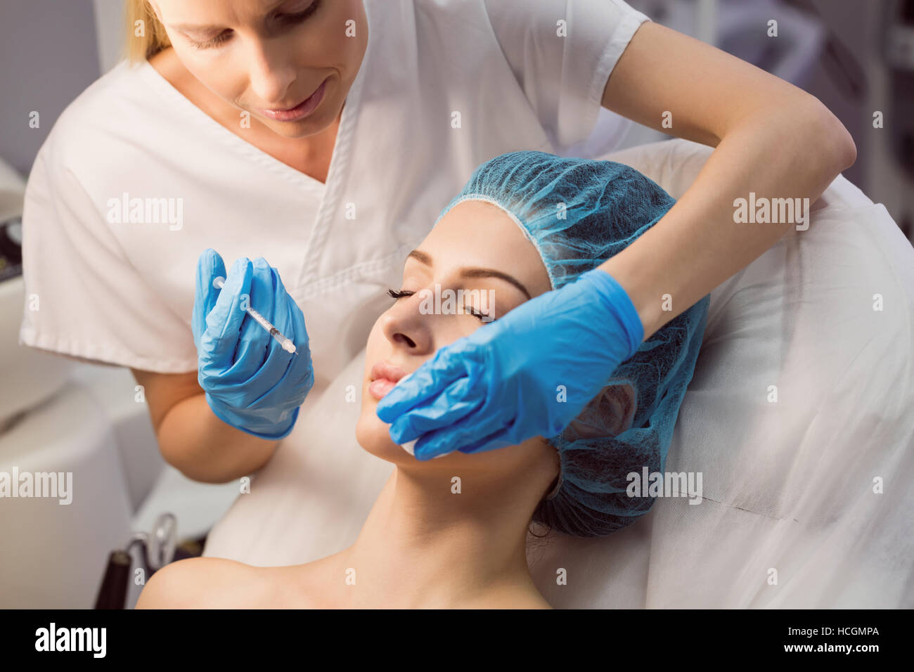 Female patient receiving an injection on her face Stock Photo - Alamy