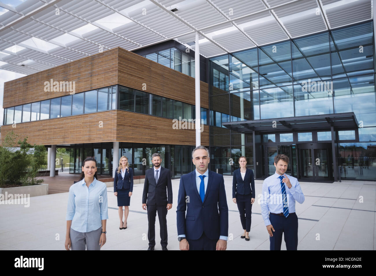 Group of businesspeople standing outside office building Stock Photo ...