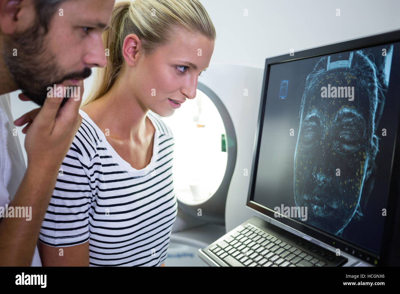 Woman looking mri scan report on computer screen Stock Photo - Alamy