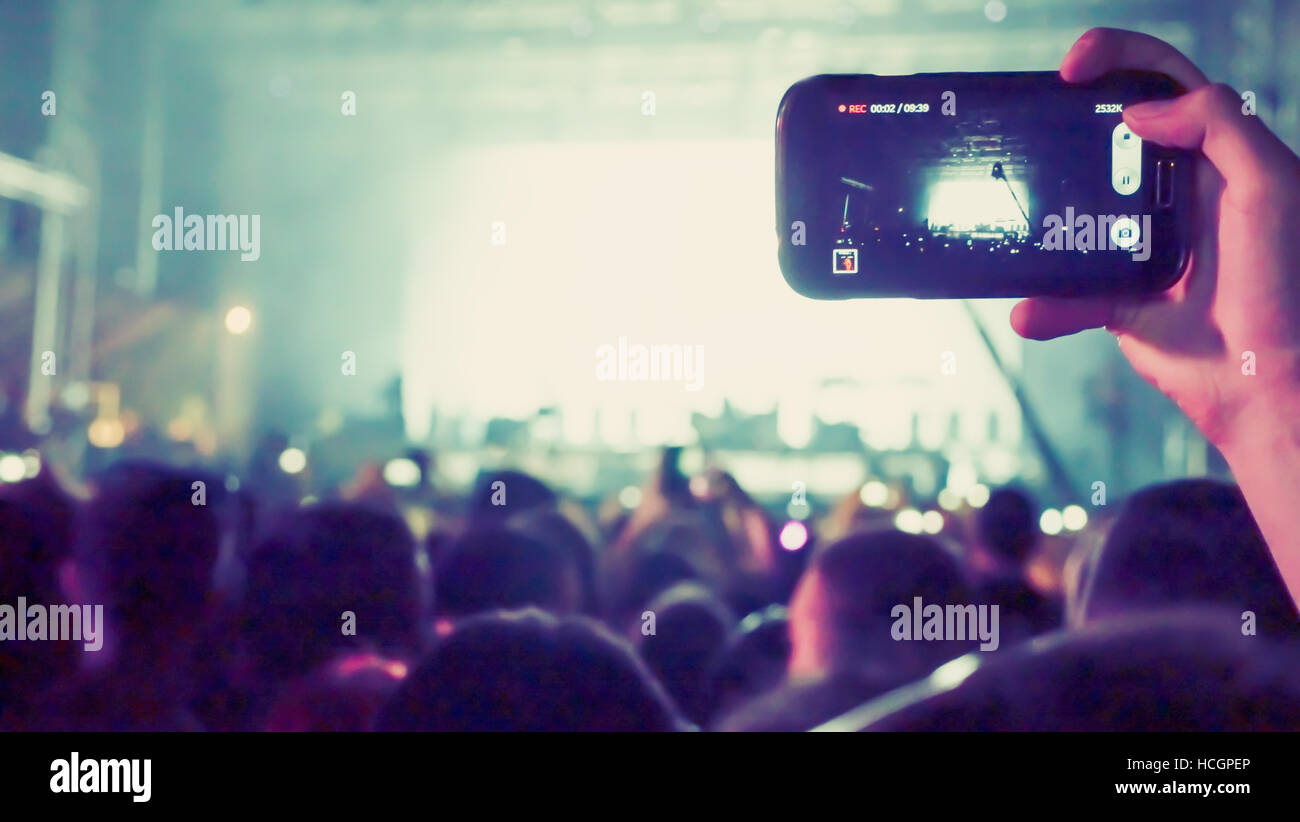Fan taking photo of concert at festival Stock Photo - Alamy