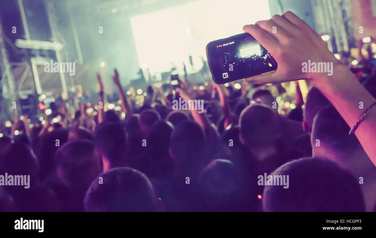 Fan taking photo of concert at festival Stock Photo - Alamy