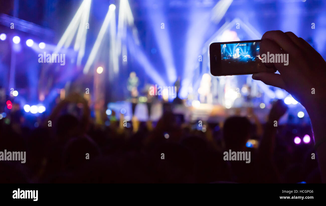 Fan taking photo of concert at festival Stock Photo - Alamy