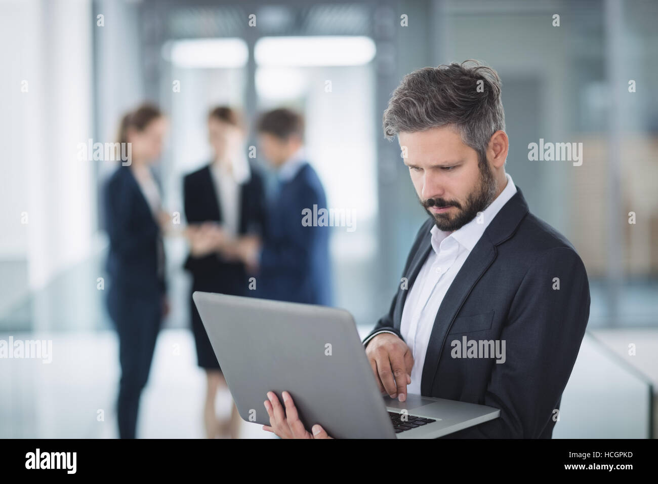 Businessman using laptop Stock Photo - Alamy