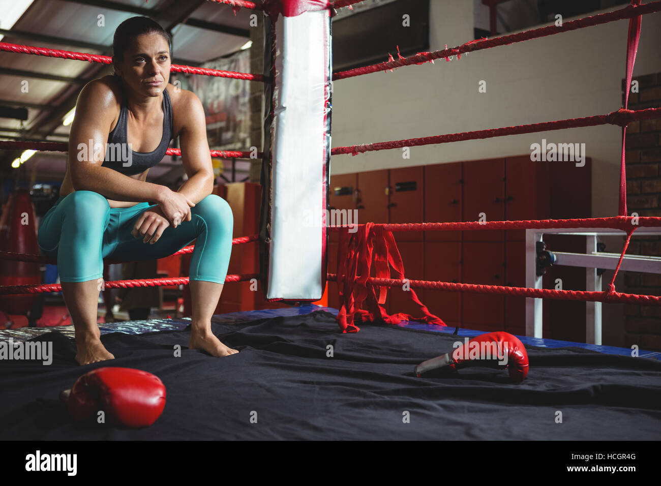 Thoughtful female boxer sitting on rope Stock Photo - Alamy