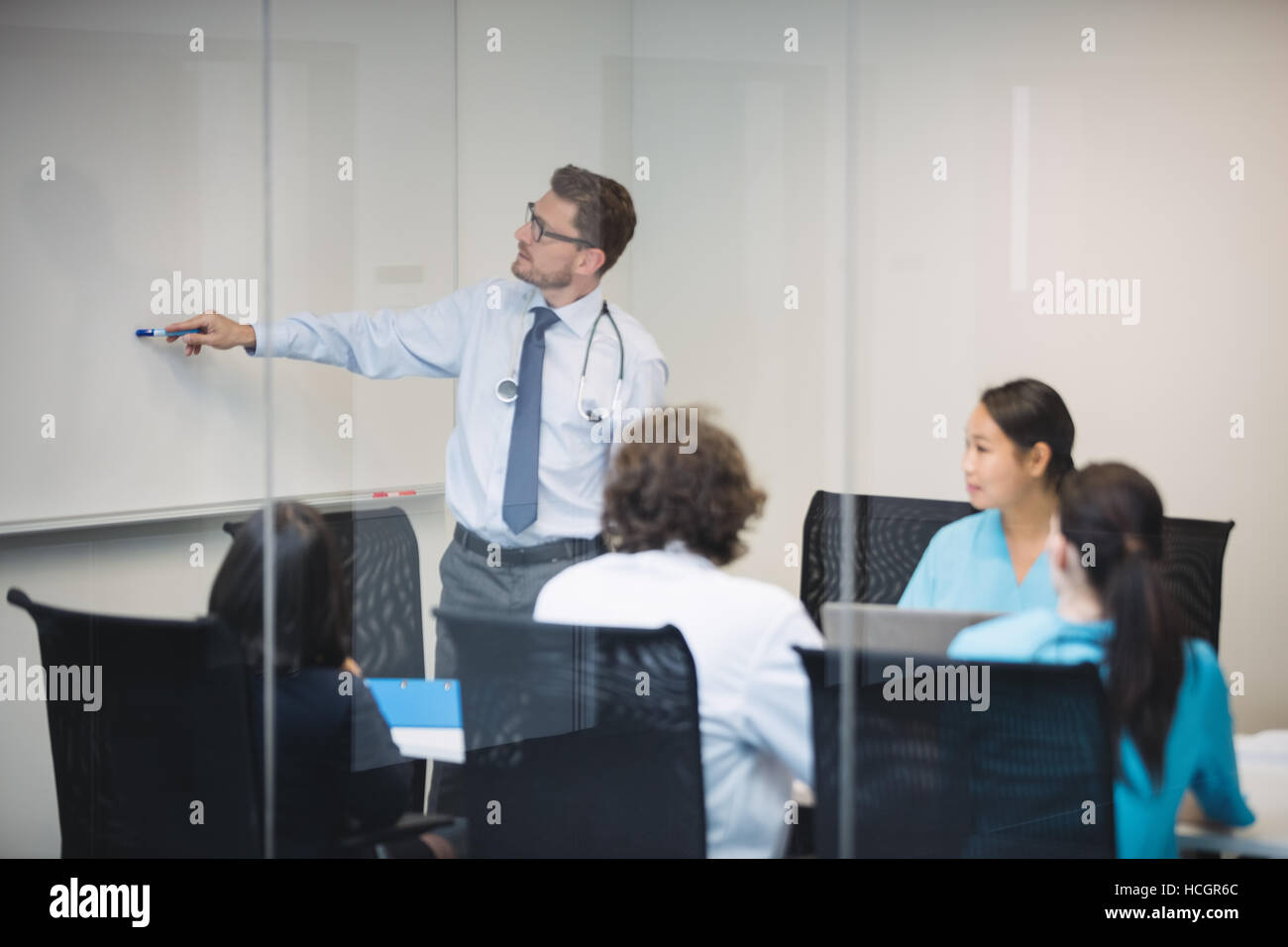 Doctor giving presentation to team of interim doctors Stock Photo - Alamy