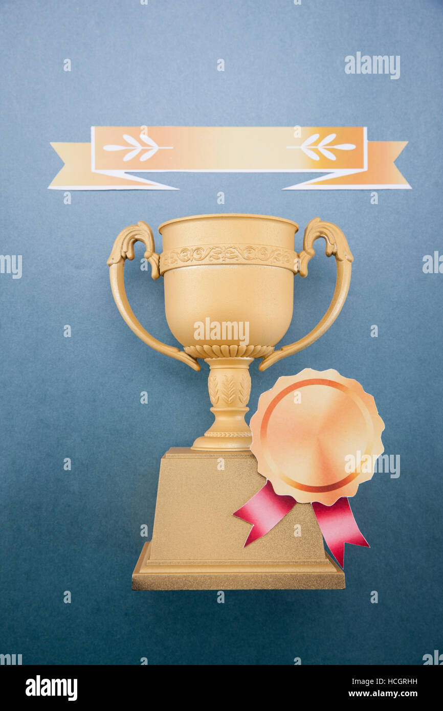 Golden trophy with ribbon and badge Stock Photo - Alamy