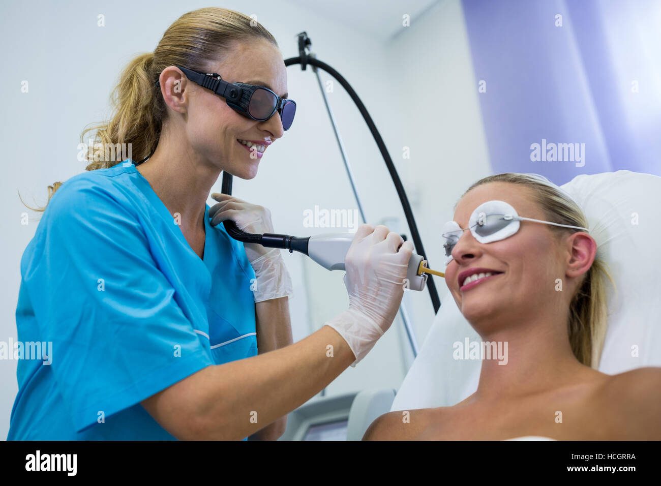 Woman receiving laser epilation treatment on her face Stock Photo - Alamy