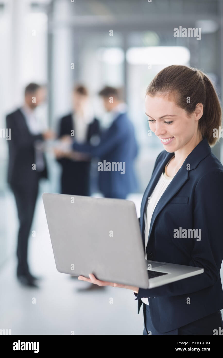 Businesswoman using laptop Stock Photo - Alamy